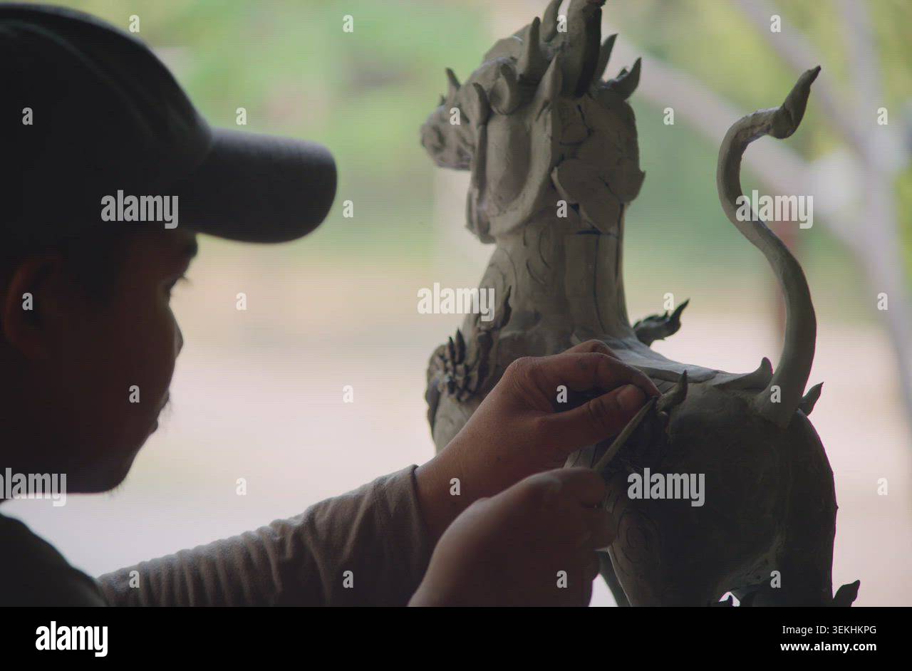 6K open gate: artisan inspecting singha cement sculpture Stock Video ...