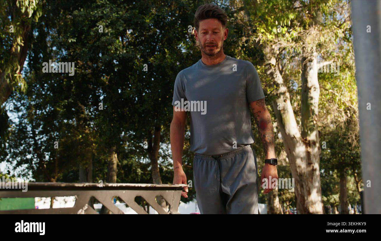 Man stretching leg on park bench for fitness Stock Video Footage - Alamy