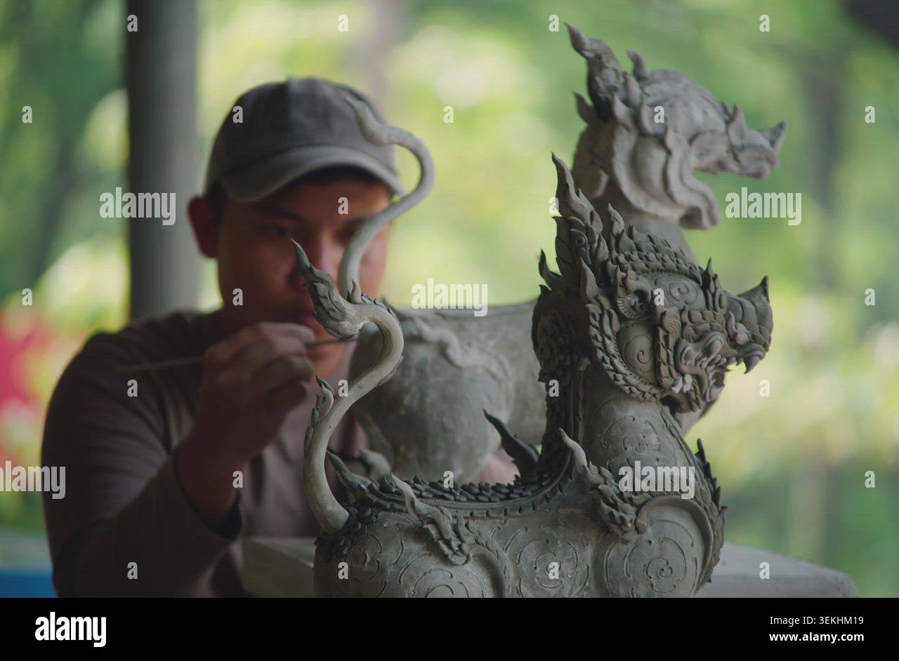 6K open gate: artisan inspecting singha cement sculpture Stock Video ...