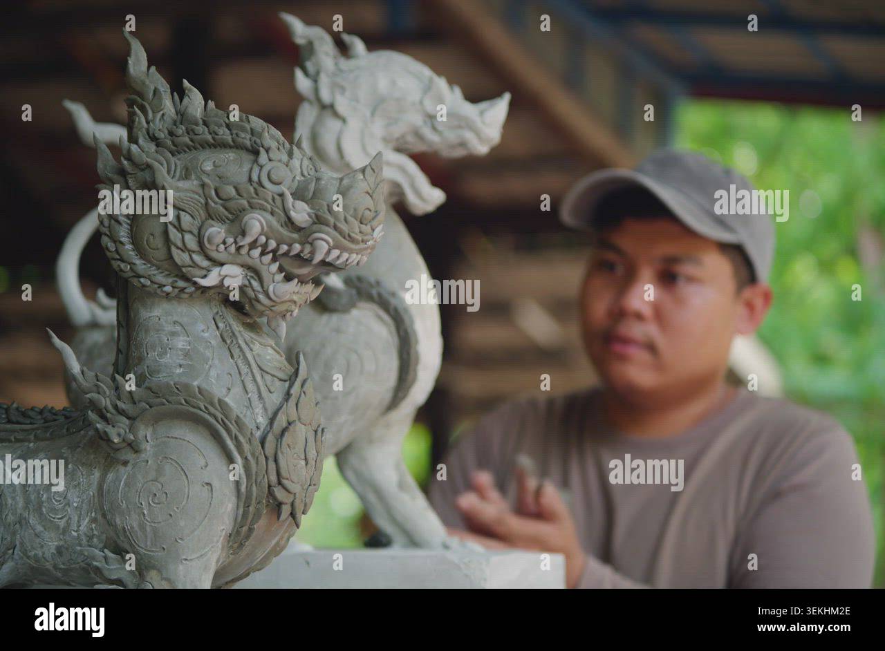 6K open gate: artisan inspecting singha cement sculpture Stock Video ...