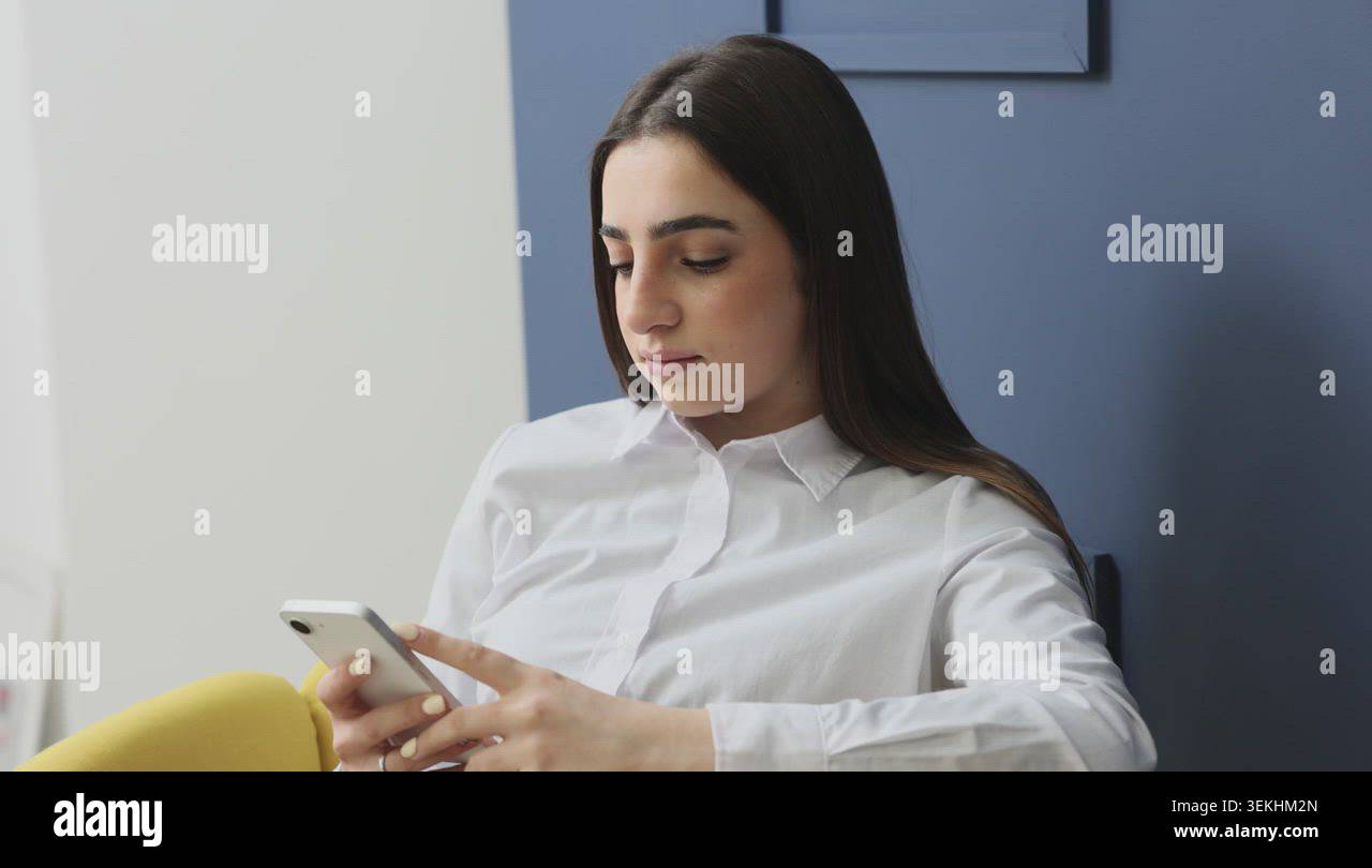 Young businesswoman smiling while texting on smartphone Stock Video ...