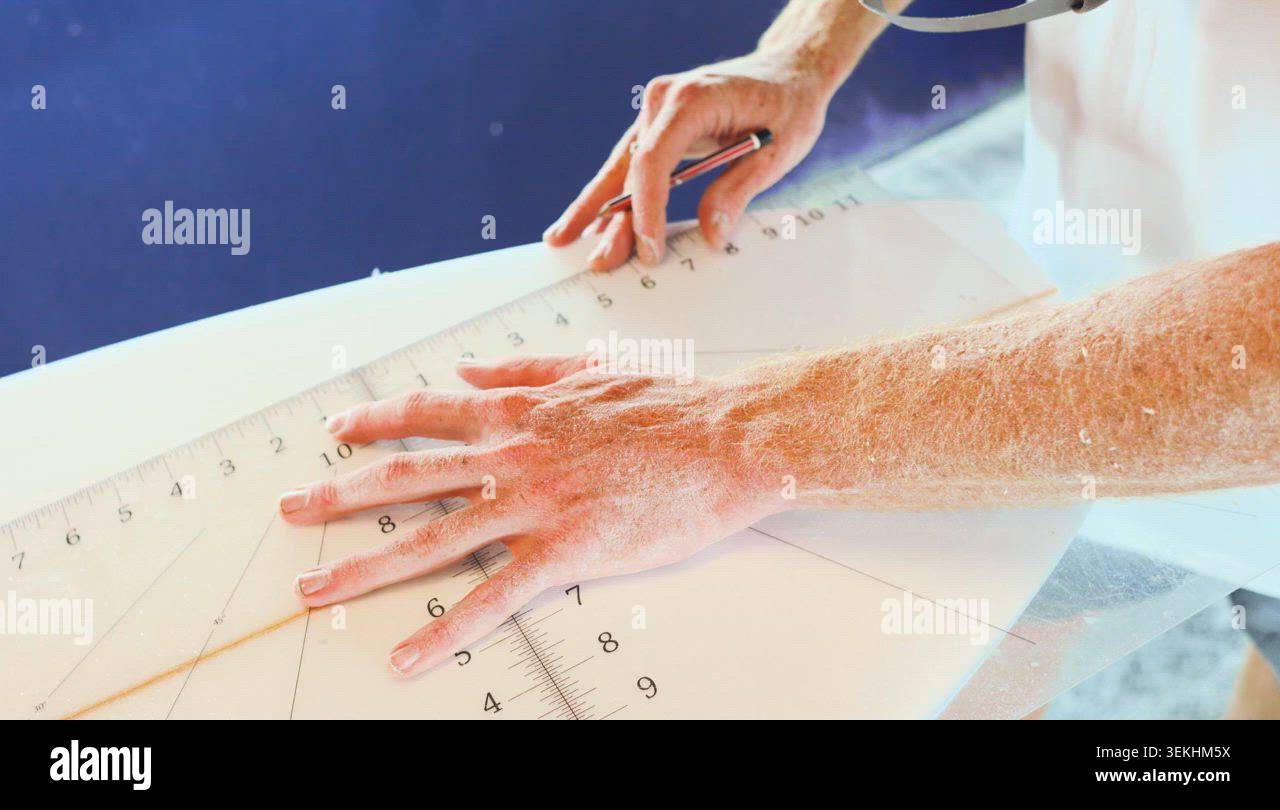 Static handheld close-up of shaper marking fin outline on blank Stock ...