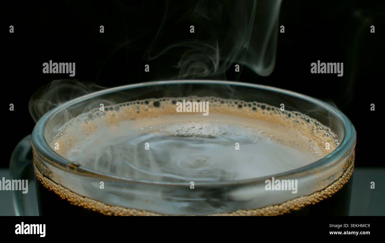 Steam rises from hot coffee in a glass cup Stock Video Footage - Alamy