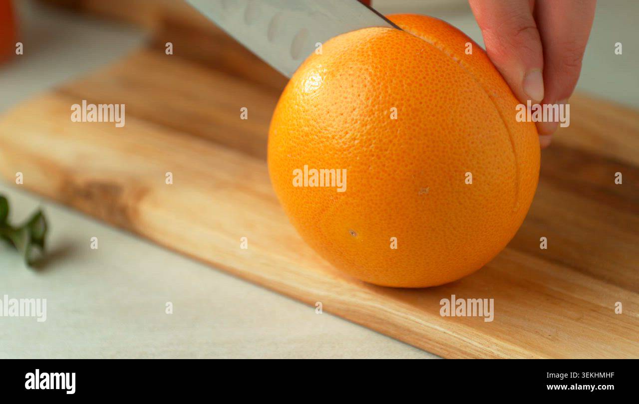 Cutting an orange with a knife Stock Video Footage - Alamy