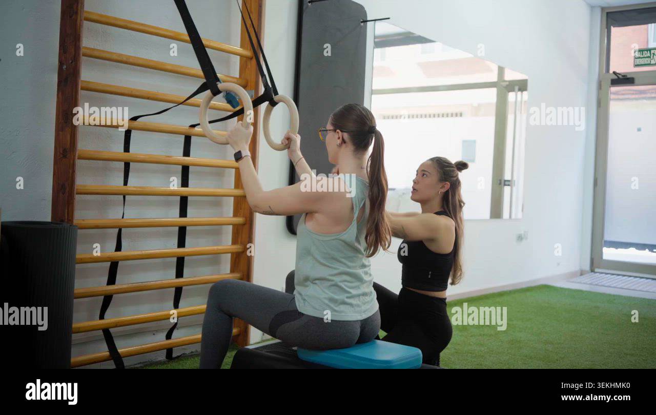 Coach with a woman during a rings workout and celebrating Stock Video ...