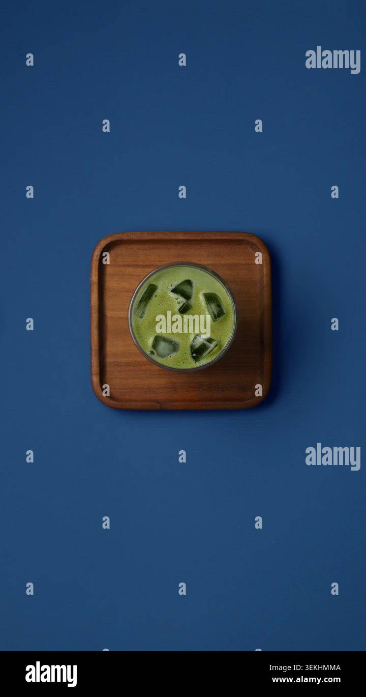 Hands presenting refreshing iced matcha drinks on wooden trays Stock ...