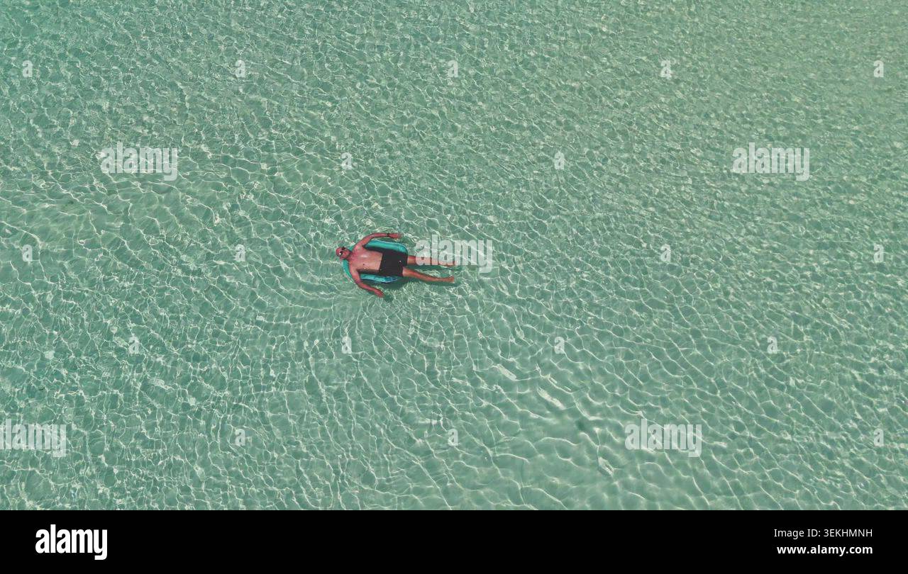 Man floating on water in The Maldives Stock Video Footage - Alamy