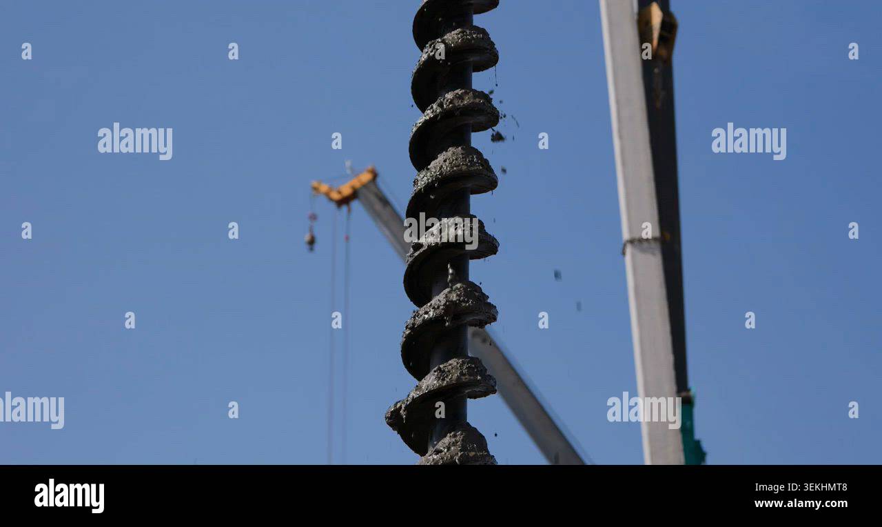 Auger drill with falling soil Stock Video Footage - Alamy