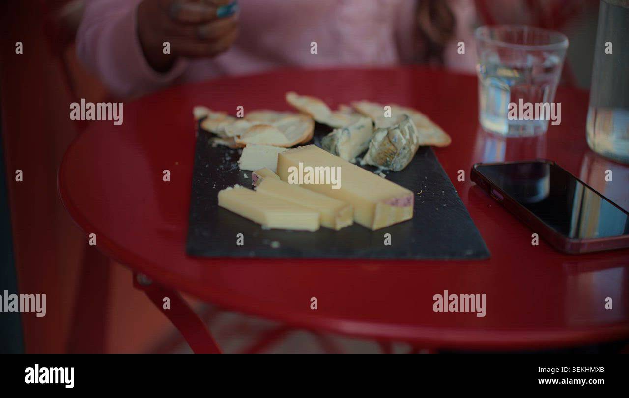 woman cutting cheese to eat on a cheese board Stock Video Footage - Alamy