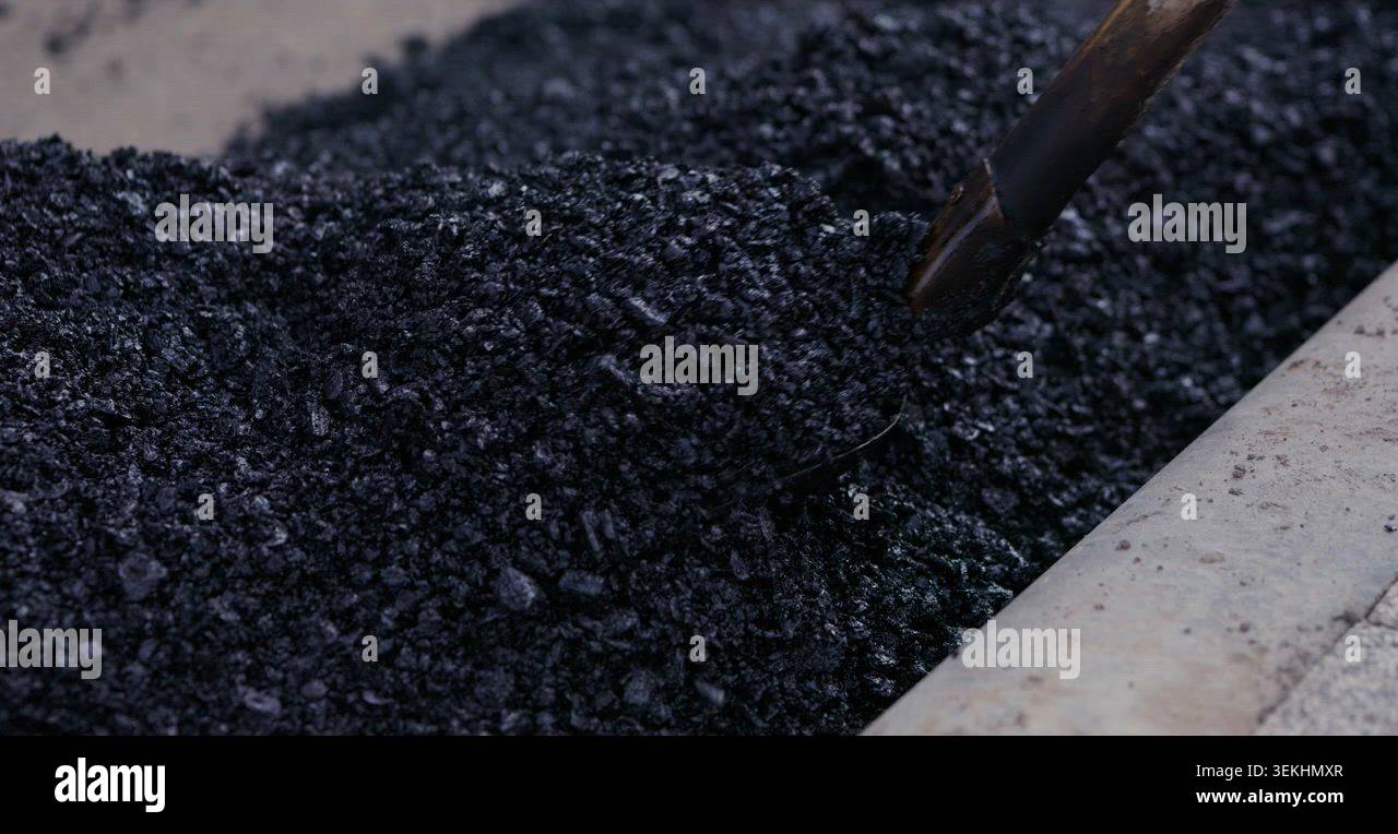 Shovel spreading hot asphalt Stock Video Footage - Alamy