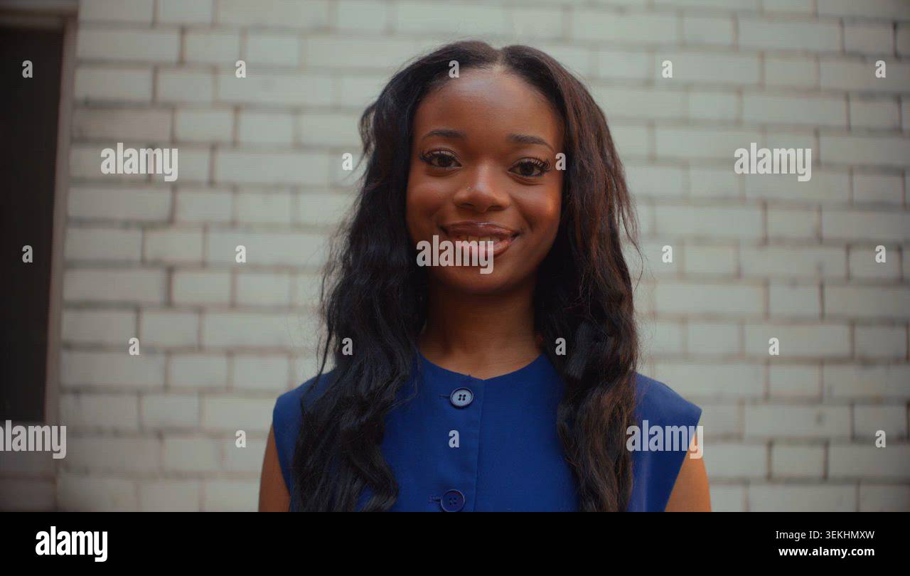 Woman Smiling in Front of Brick Wall During Sunny Day Stock Video ...