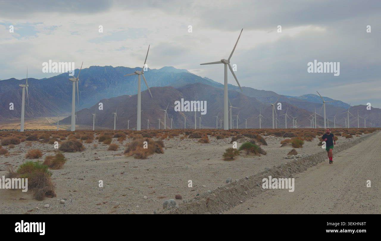 Athlete trail running desert Wind turbine farm Stock Video Footage - Alamy