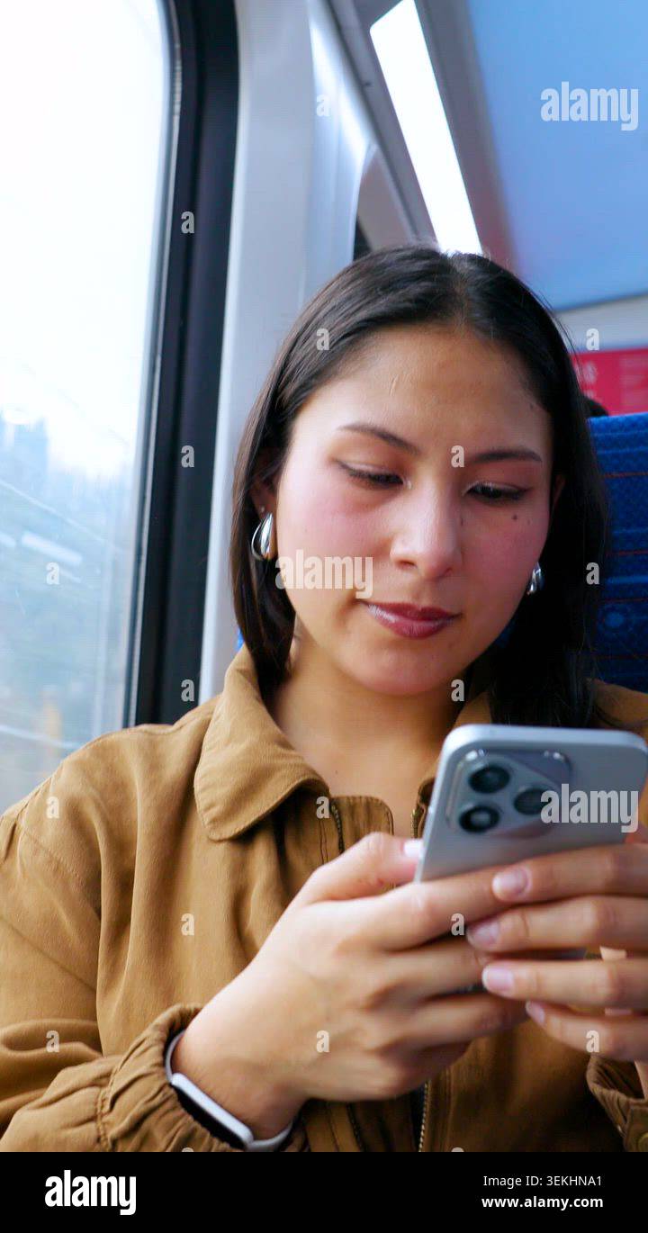 Smiling woman with phone on train Stock Video Footage - Alamy