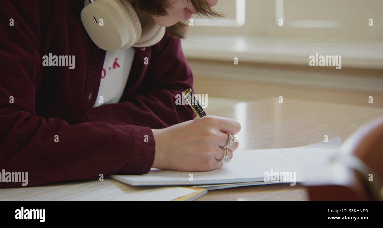 Student writing homework and studying in library Stock Video Footage ...