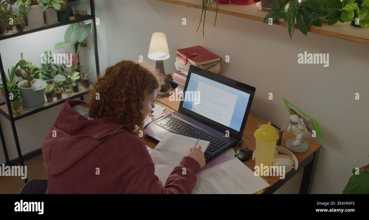 Student learning using laptop and taking notes Stock Video Footage - Alamy