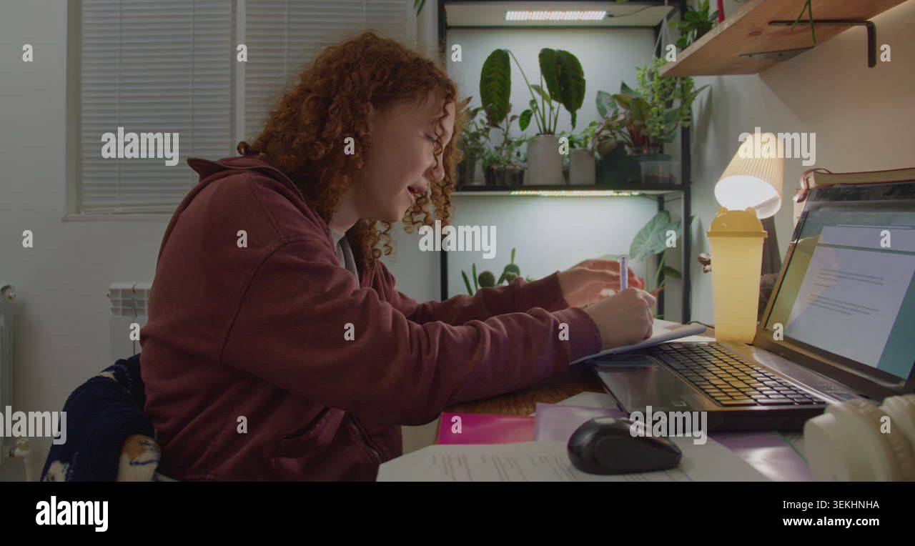 Sleepy student yawning while studying at night with a laptop Stock ...