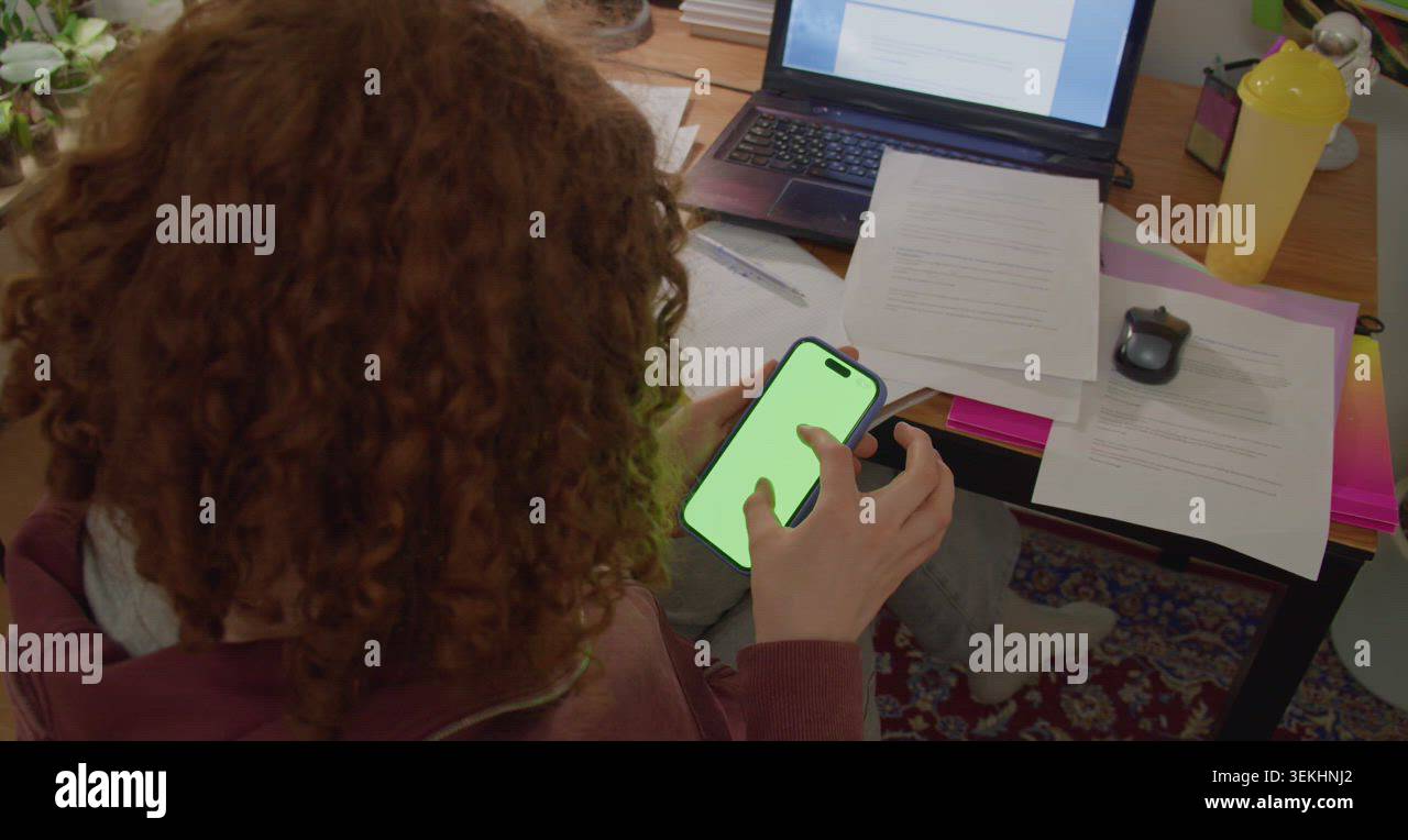Student using smartphone with green screen while studying Stock Video ...