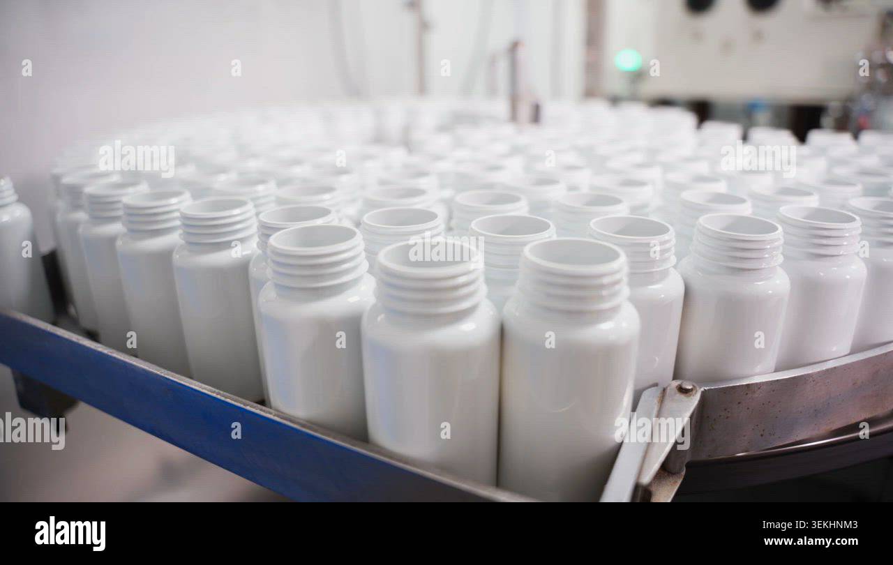 Pharmaceutical pill bottles moving on a conveyor belt Stock Video ...