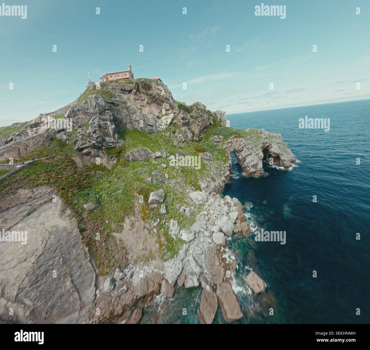 FPV drone dive along Gaztelugatxe zig-zag stairs to sea, Spain Stock ...