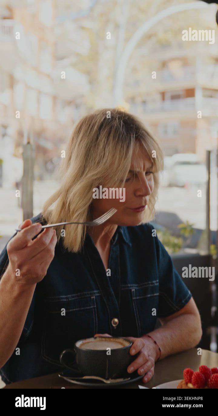 Woman having a pastry and coffee outdoors Stock Video Footage - Alamy