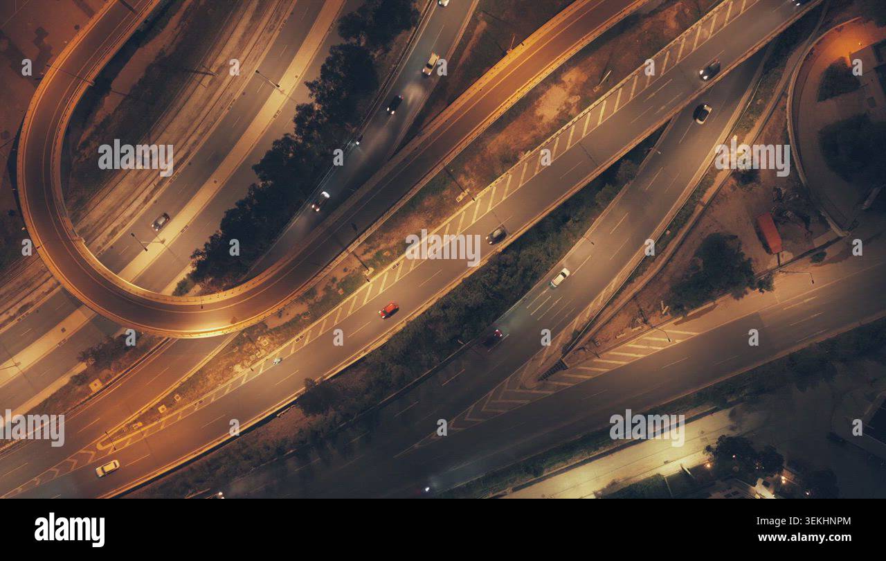 Aerial view of a highway interchange traffic flow at night Stock Video ...