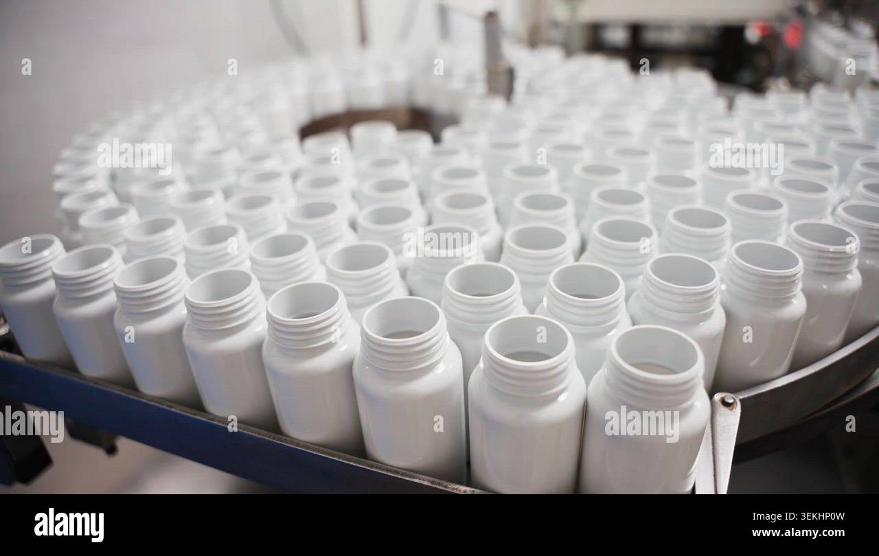 Pharmaceutical pill bottles moving on a conveyor belt Stock Video ...