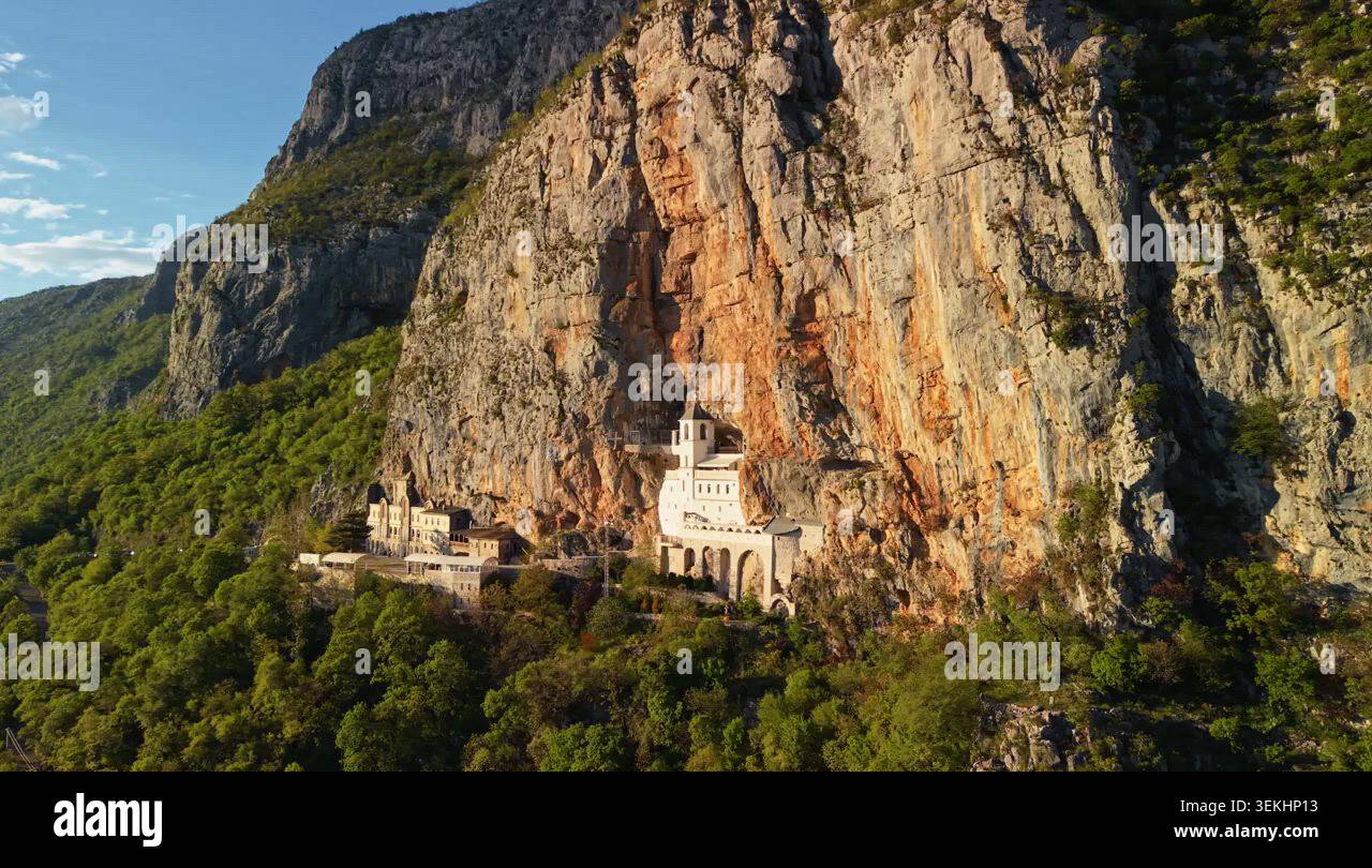 Ostrog Monastery in Montenegro, aerial establishing shot at sunset ...