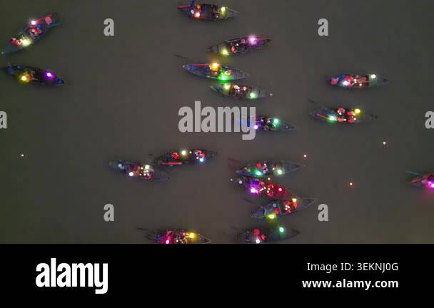 Top-down aerial view of Thu Bon River at night with sailing boats ...