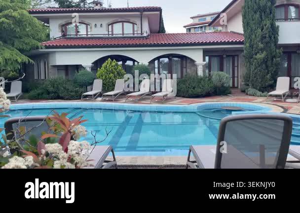 Widescreen 4K video of a cozy two-story resort hotel building with a ...