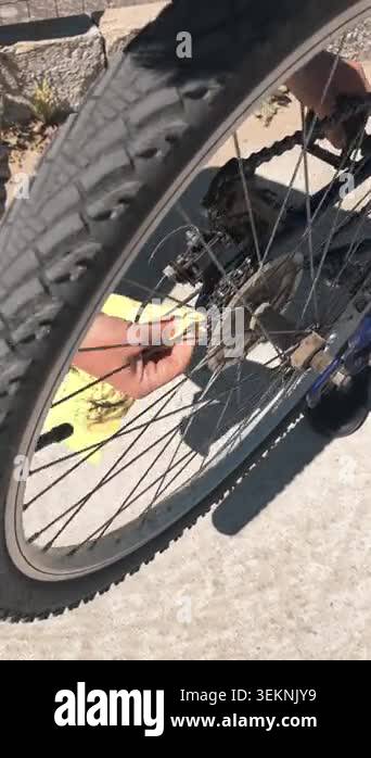 Slow Motion Close-Up of Mechanic Wiping Bicycle Chain with Rag while ...
