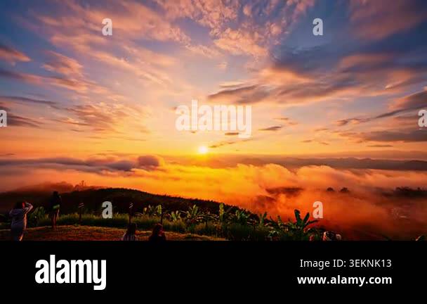People enjoying sunset view over mountains with clouds in a scenic ...