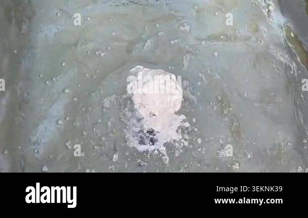 Top down slow motion view of clean water spraying and splashing from a ...