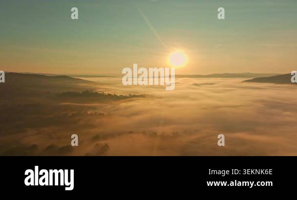 Drone view of mountains wrapped in soft morning mist Stock Video ...