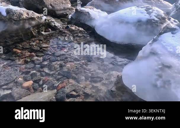Winter natural phenomenon in which coastal rocks are covered by a thick ...