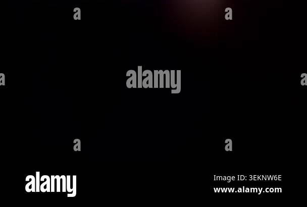 Slow motion of lens flare isolated on black background. Anamorphic lens ...