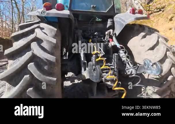 Rear view of a farm tractor, tractor on the road, big tractor wheels ...