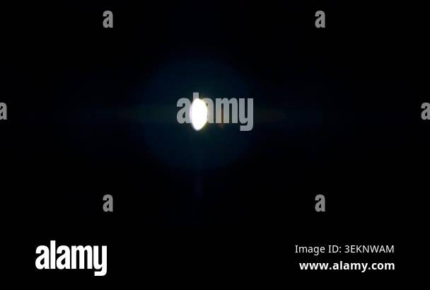 Slow motion of lens flare isolated on black background. Anamorphic lens ...