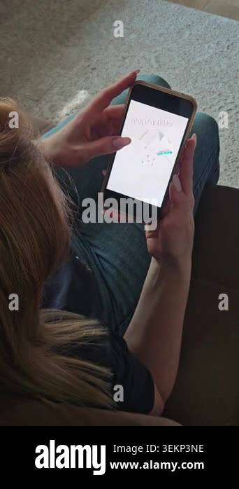 Woman sitting at home and holding smartphone with hantavirus warning ...