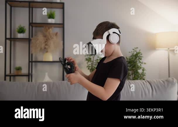 Young person wearing VR headset and holding controller in living room ...