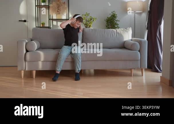 Young boy engrossed in mobile game, indoors, focused expression ...