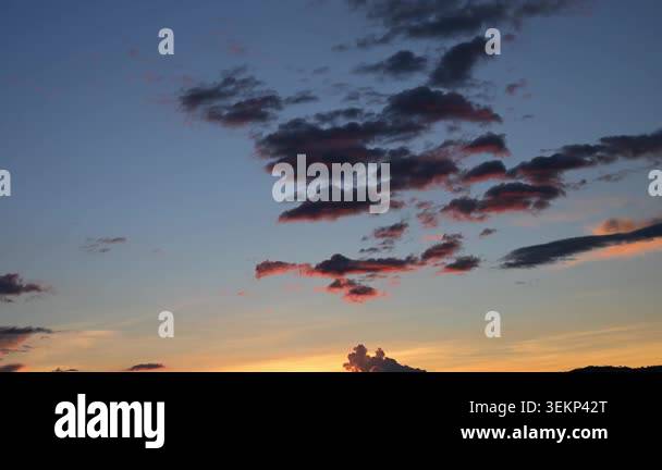 Dramatic evening sky showing dark clouds gracefully floating across a ...