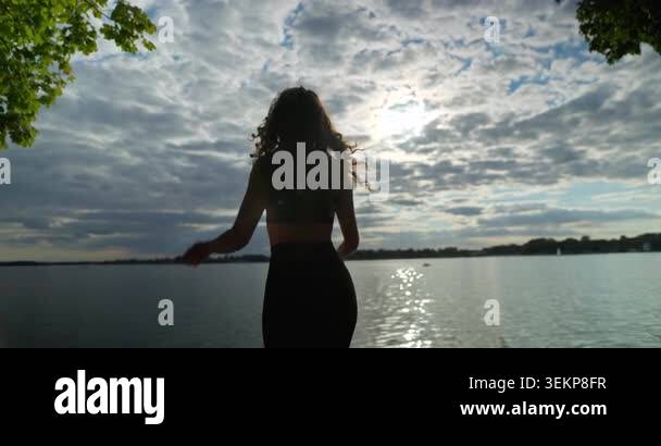 A tranquil lake mirrors a serene silhouette, capturing a deep sense of ...