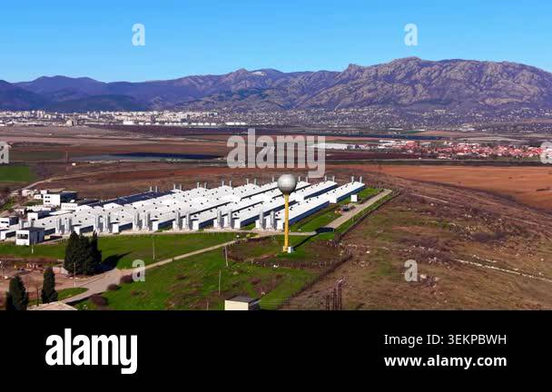 Industrial farm complex with water tower. Elevated drone view of white ...