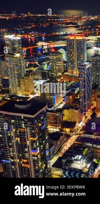 Aerial nighttime view of Miami downtown with lit towers, Ferris wheel ...