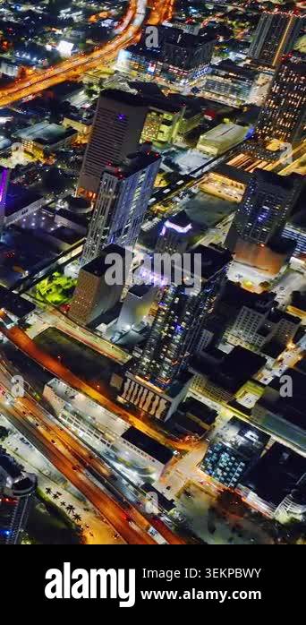High-altitude aerial nighttime view of Miami downtown dense street grid ...