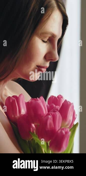 Profile of a young woman with light brown hair bathed in warm, soft ...