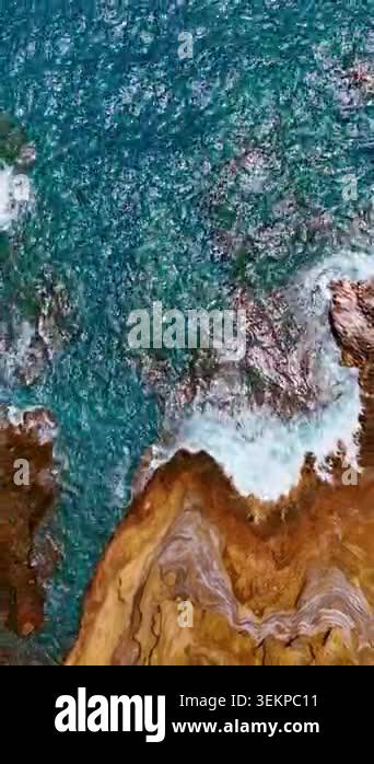 Top-down aerial view of turquoise and dark teal ocean surface with ...