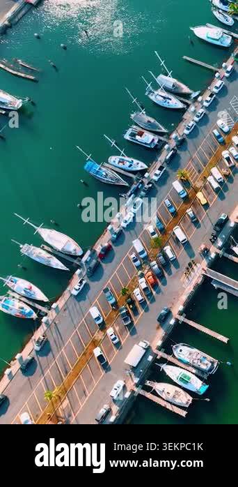 Overhead aerial view of marina with multiple sailboats and motorboats ...