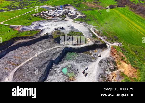 High angle landscape view showing terraced stone extraction site next ...