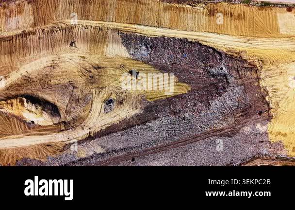 Direct above shot of earthmoving equipment covering crushed domestic ...